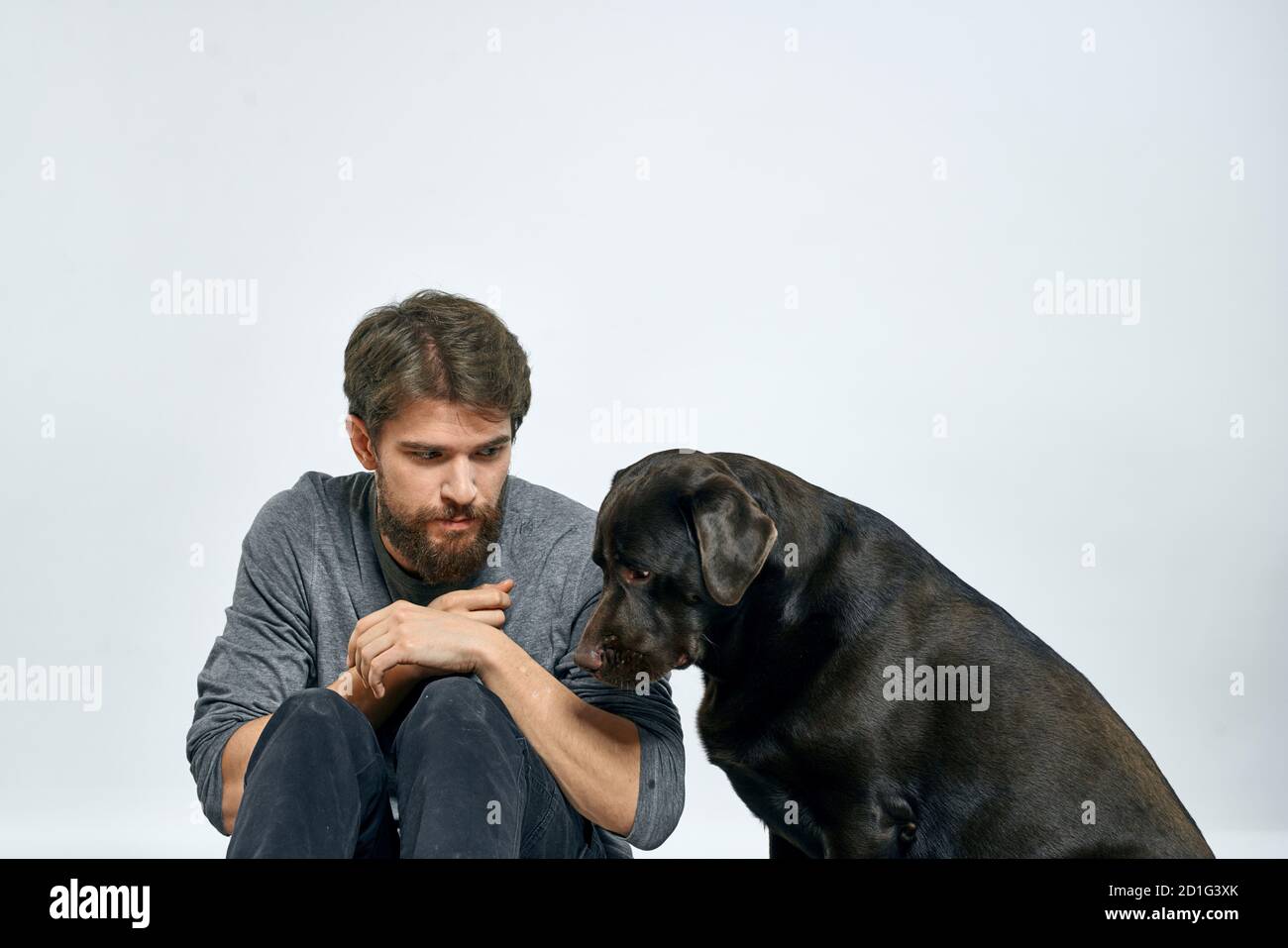 happy owner with pet black dog training model emotions Stock Photo - Alamy