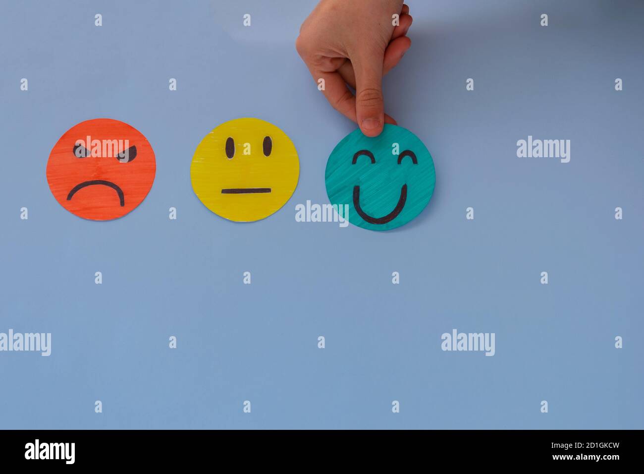Overhead shot of a person choosing a smiling face representing a ...
