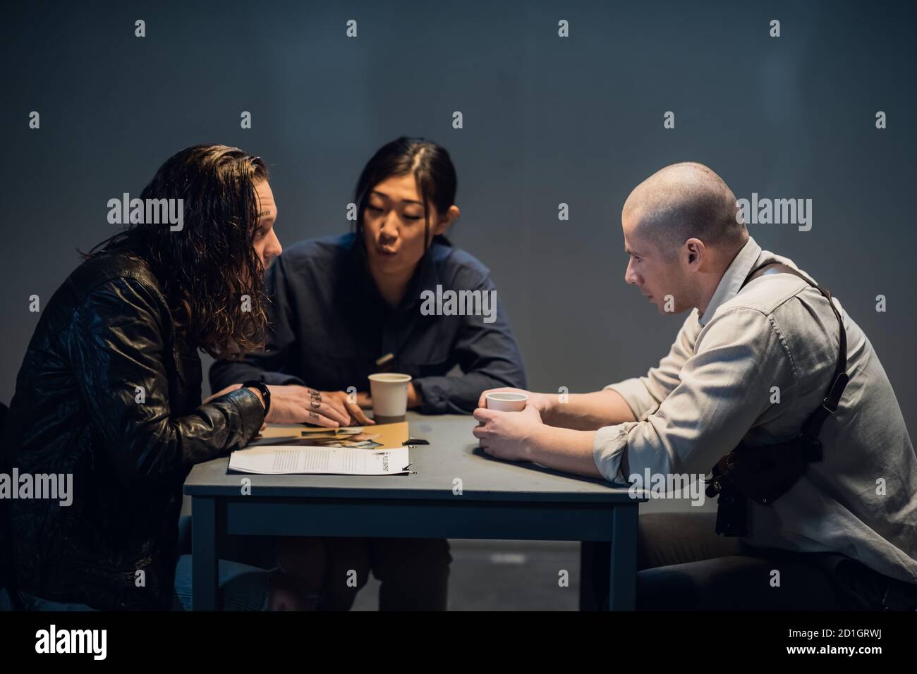 At the police station, two officers are interrogating the captured ...