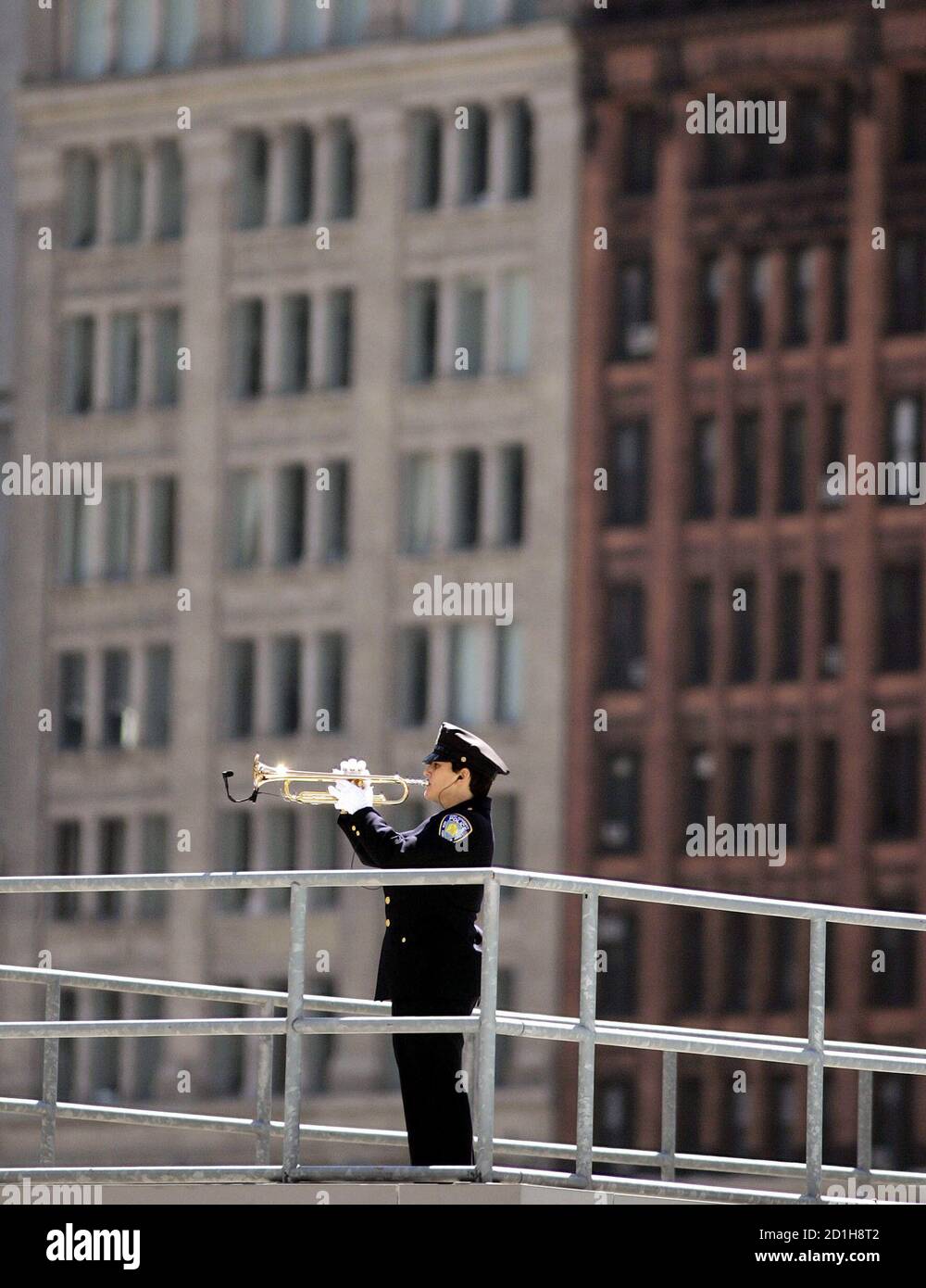 A New York City Police department trumpeter plays taps at the end of ...