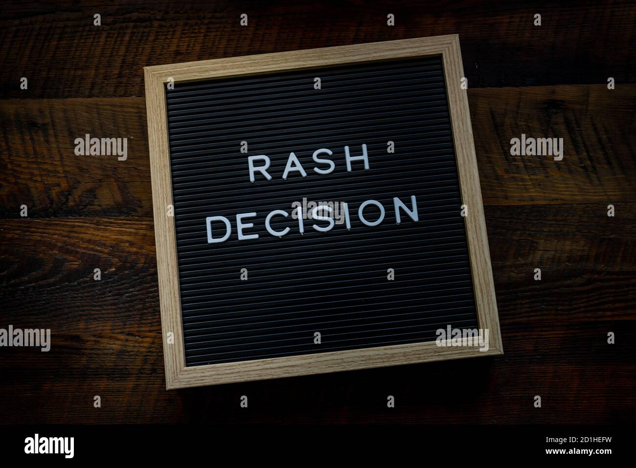 Rash Decision message on chalkboard centered on wooden background Stock ...