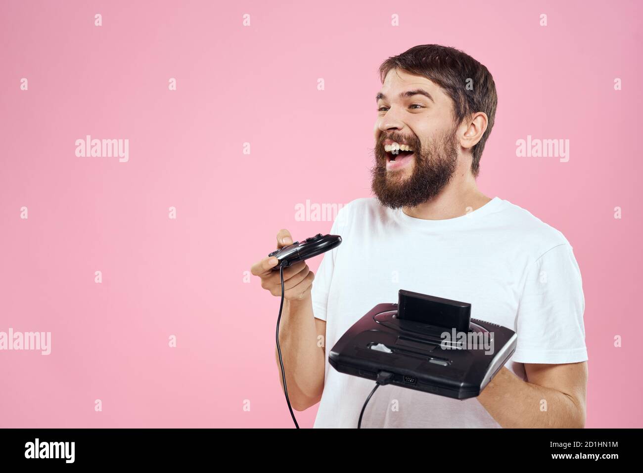 Man with prefix in hand joystick games lifestyle fun pink background ...