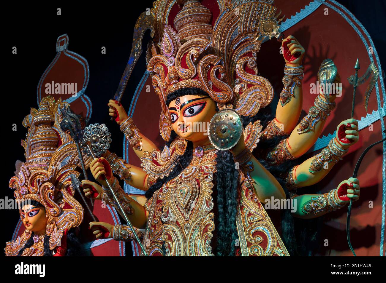 Goddess Durga idol , Durga Puja festival at night. Shot under colored ...