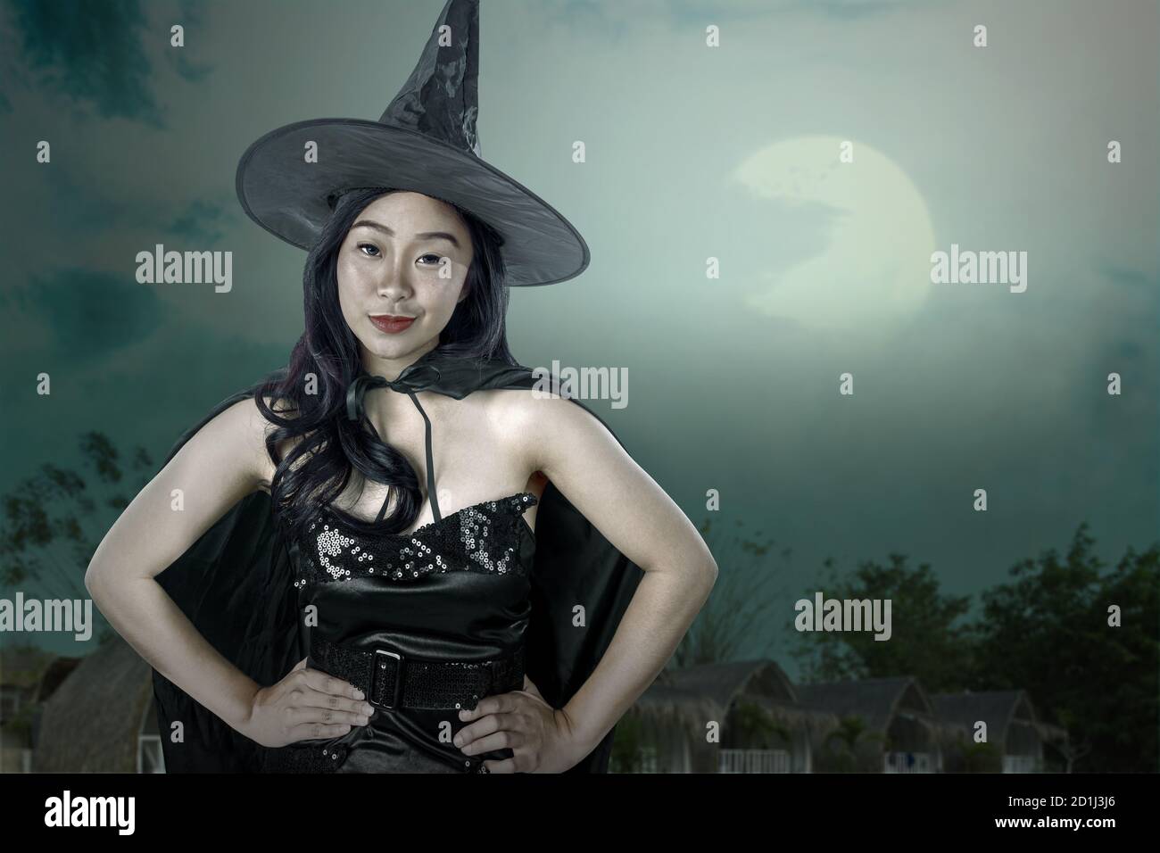 Asian witch woman with a hat standing with the night scene background ...