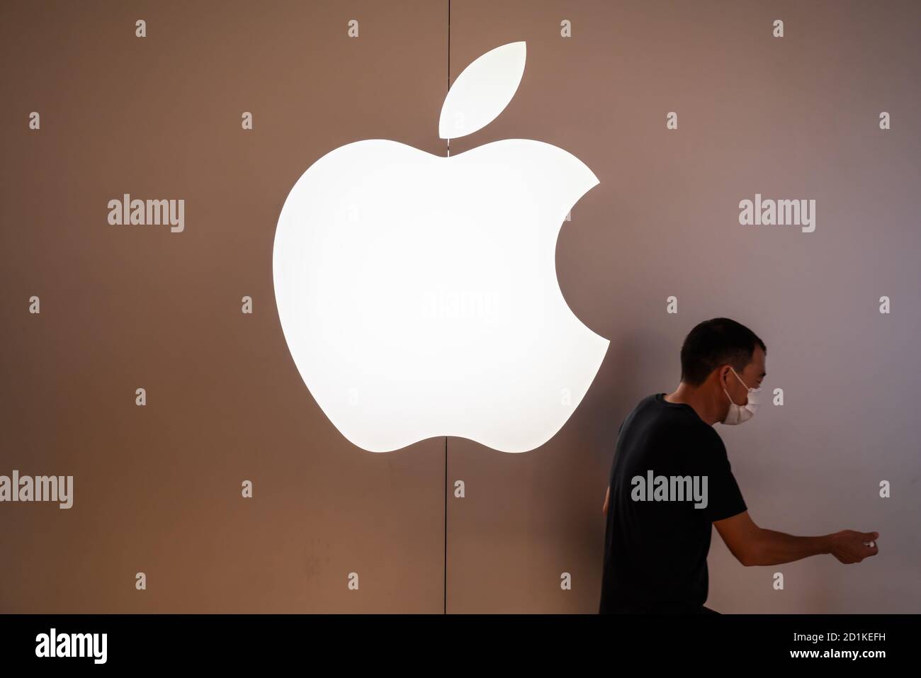 Shenzhen, China. 05th Oct, 2020. Pedestrian walks past an Apple logo at ...