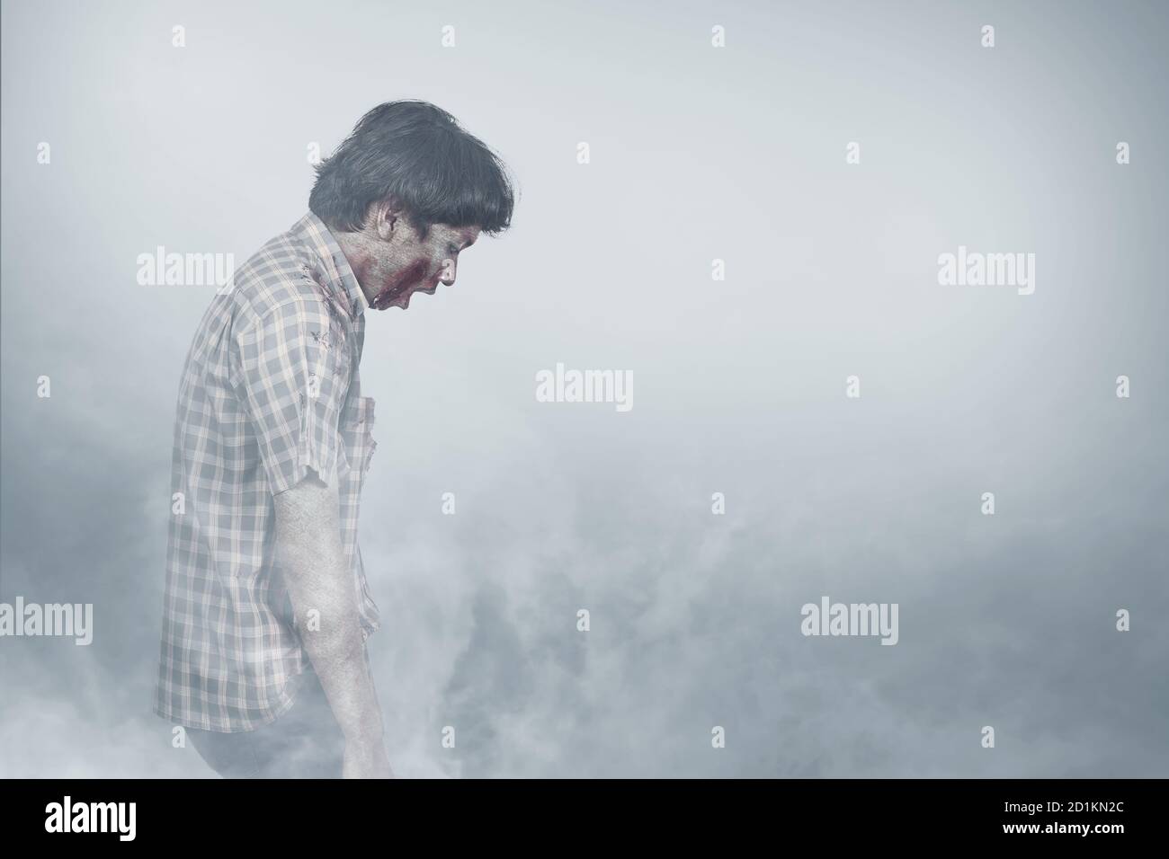 Scary zombie with blood and wound on his body standing in the fog Stock ...