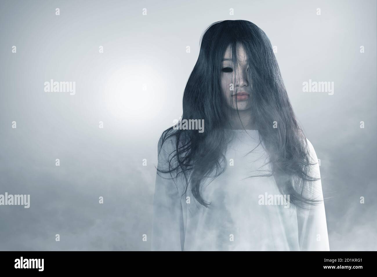 Scary ghost woman standing in the fog. Halloween concept Stock Photo ...