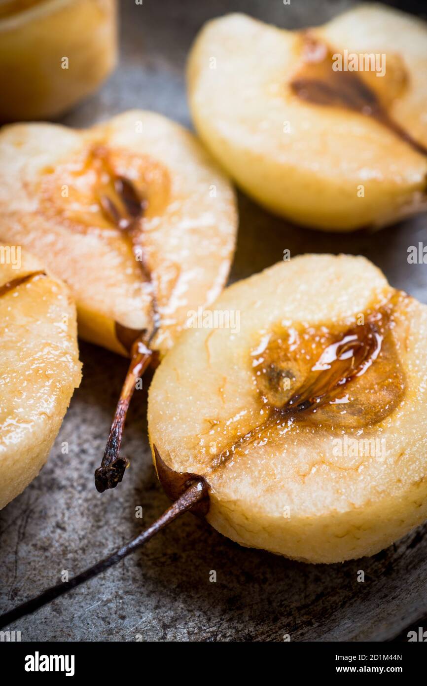 Grilled pears with cinnamon and honey on the rustic background ...
