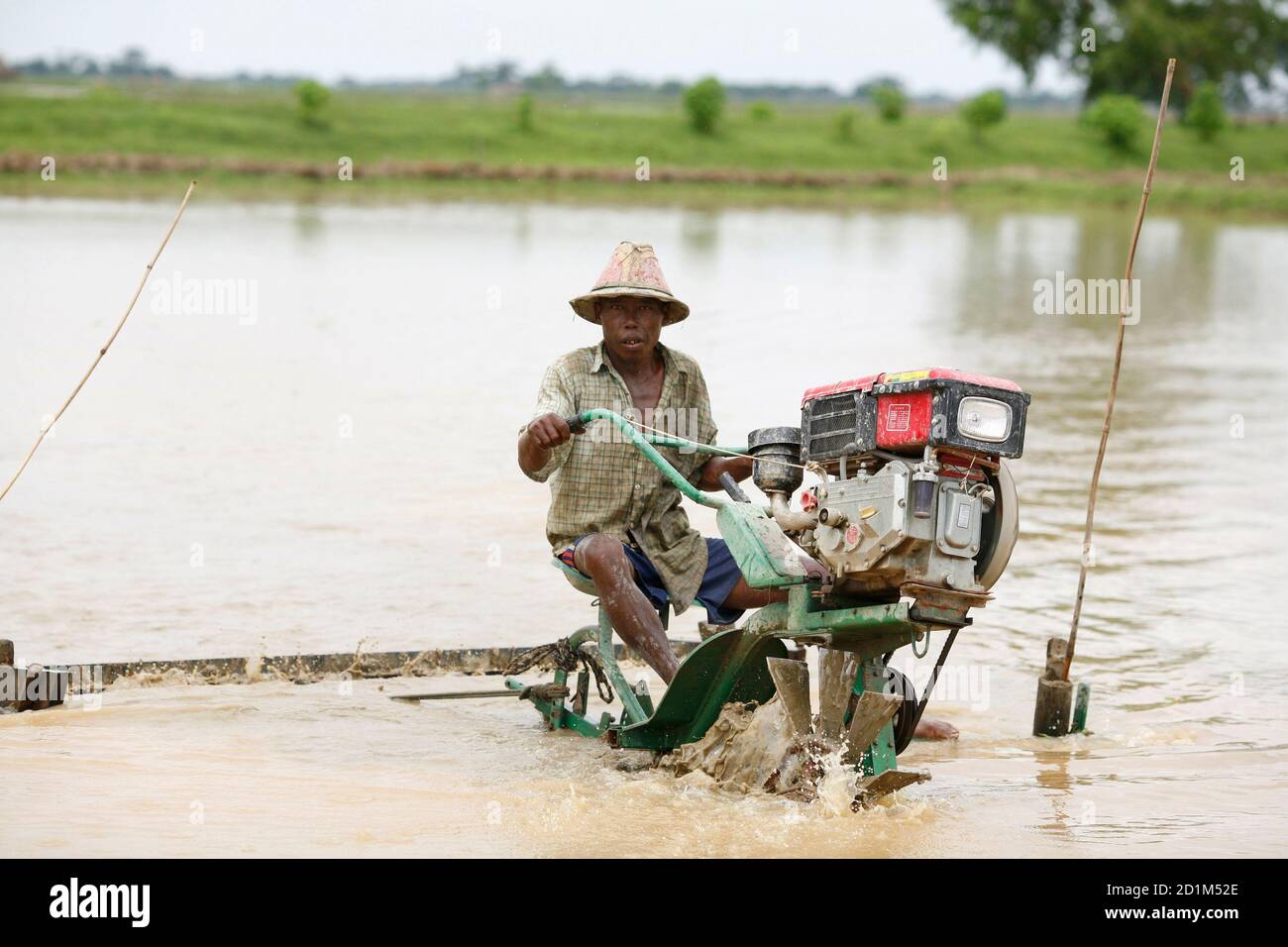 Man with plough in paddy field hi-res stock photography and images - Alamy