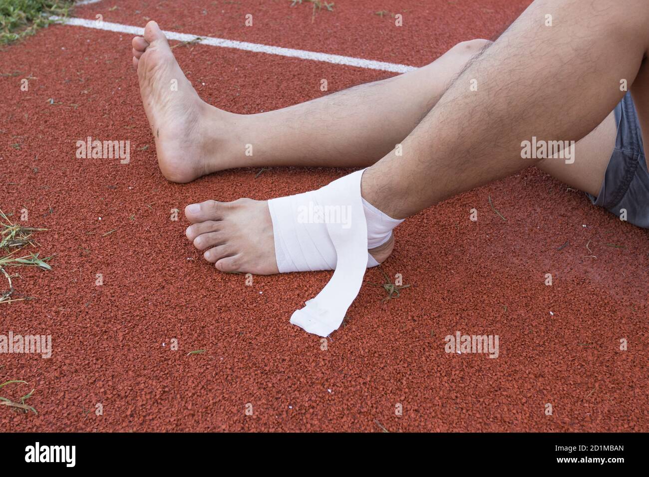 man applying compression bandage onto ankle injury After exercise ...
