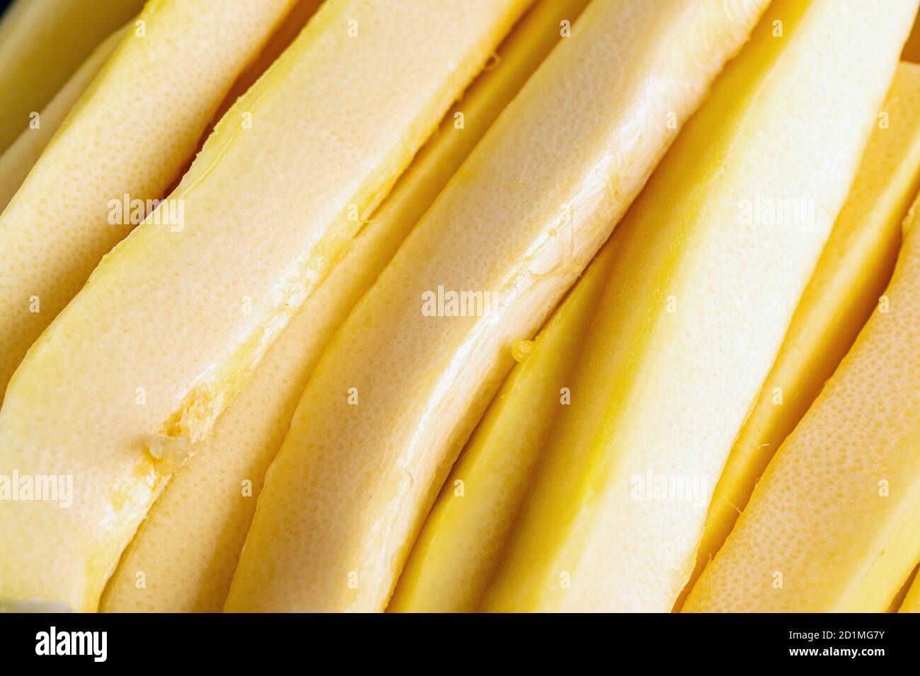 peeled strips of zucchini stacked in row close-up. Natural texture ...