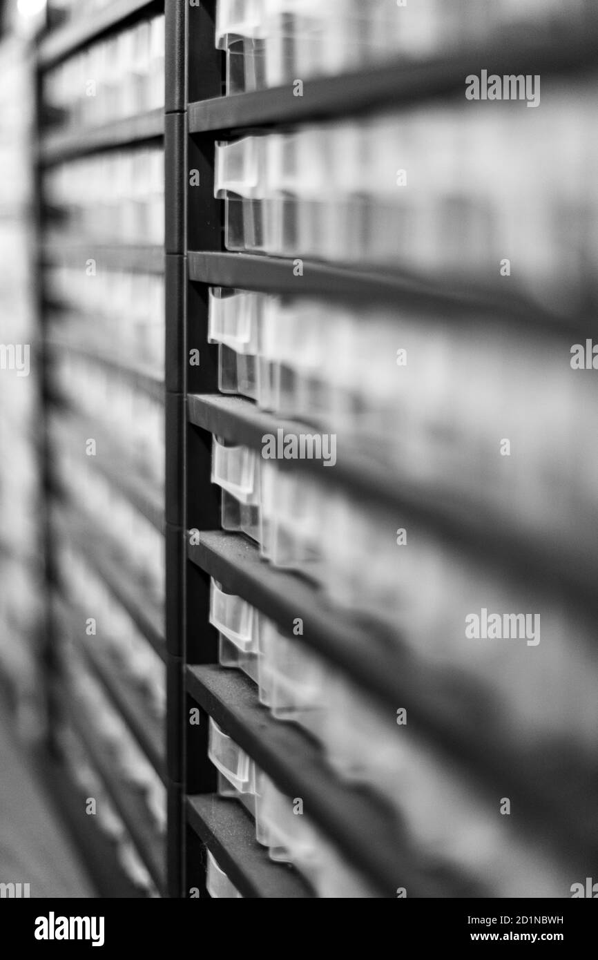 monochrome closeup of a shelf for screws or other equipment, garage ...