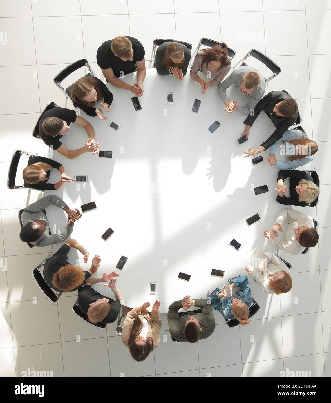 Sitting at a round table hi-res stock photography and images - Alamy