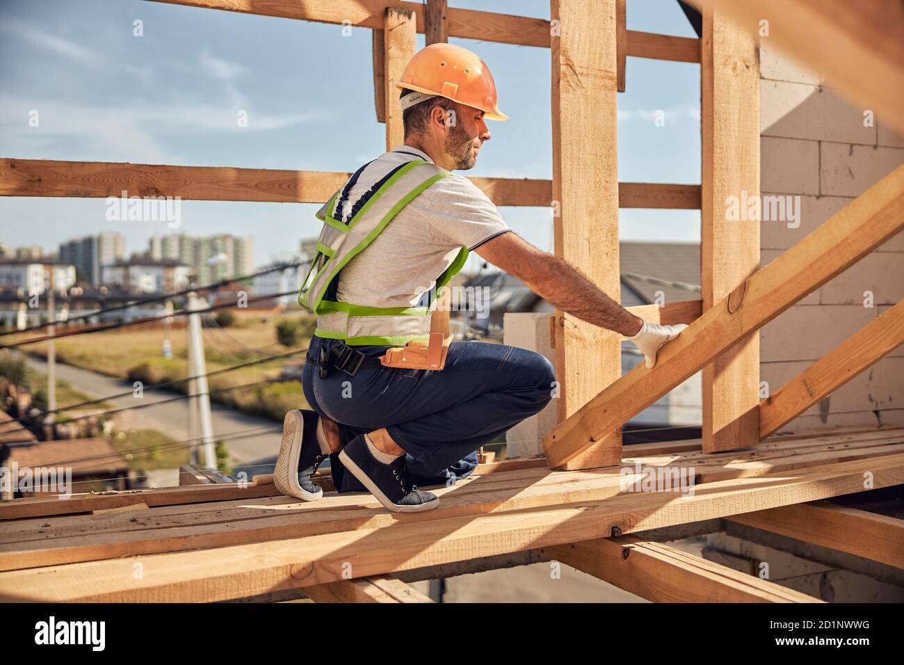 Serious constructor standing on the top floor of building Stock Photo ...