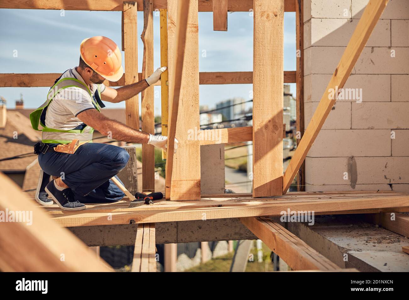 Serious worker measuring distance before fastening screws Stock Photo ...