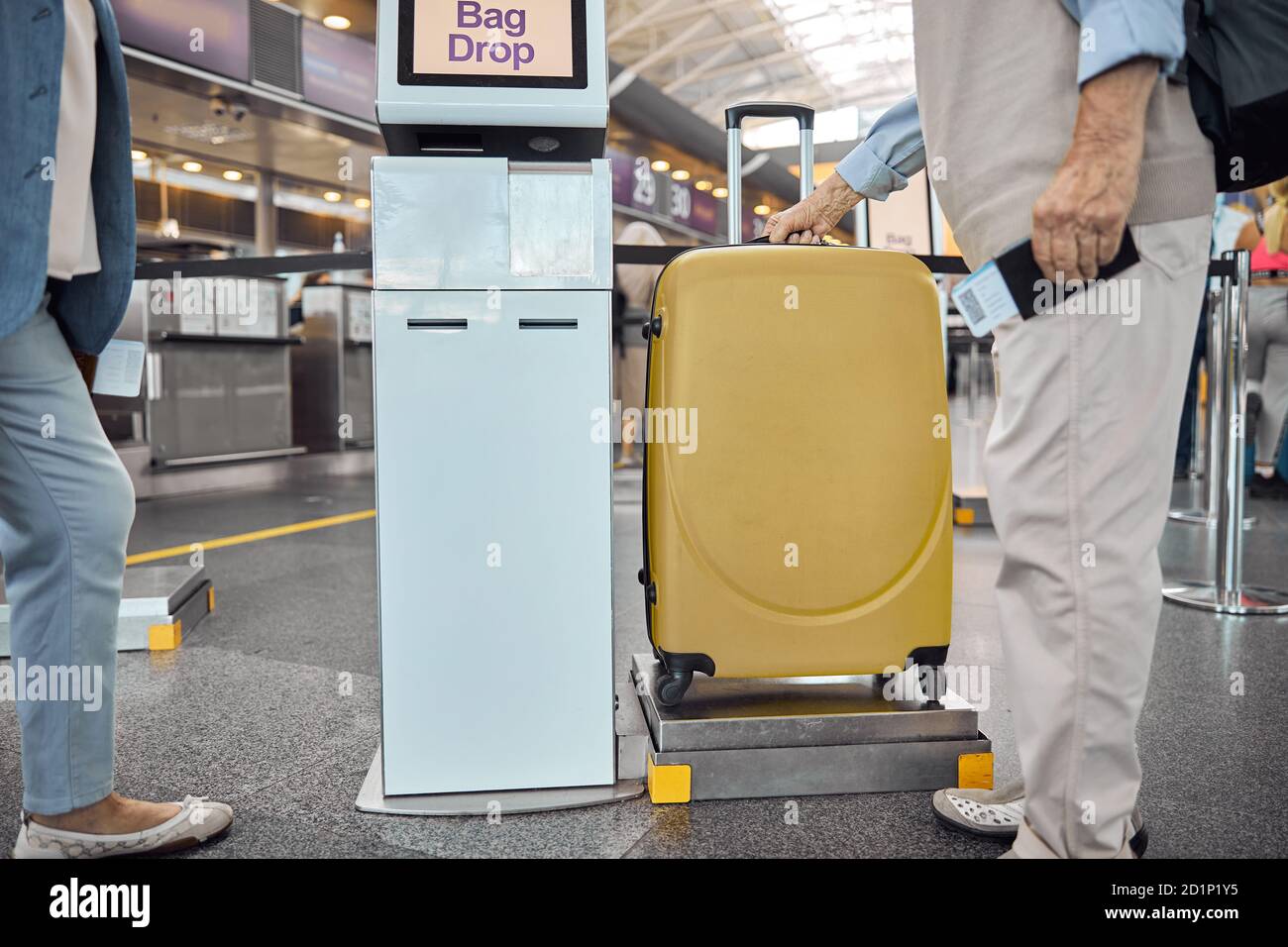 Two Caucasian passengers using a self-service unit Stock Photo - Alamy