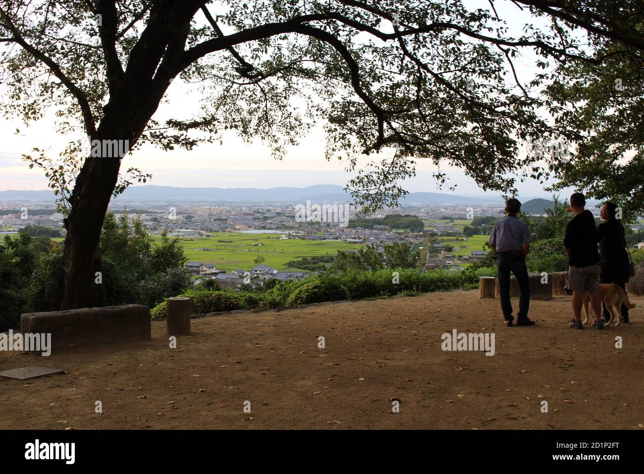 People enjoying the view of Asuka town in Nara as seen from Amakashi no ...