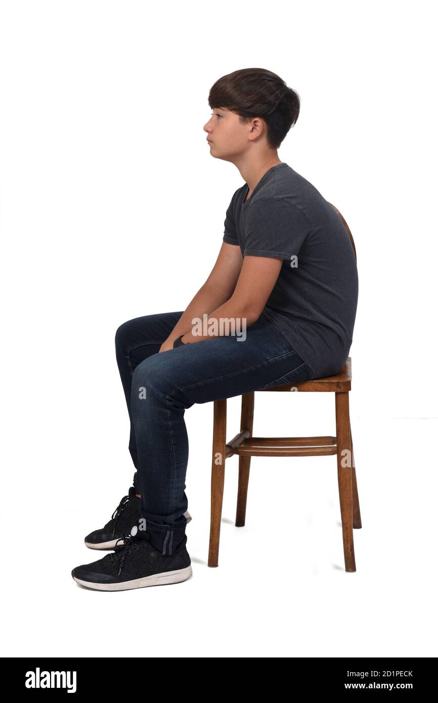 teenage boy sitting on a chair with white background,look side Stock ...