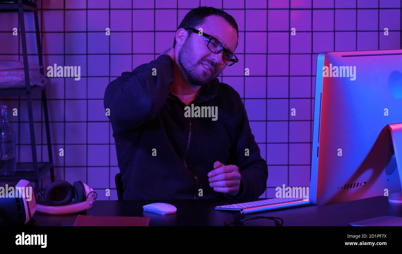 A programmer working on his computer having pain in his neck Stock ...