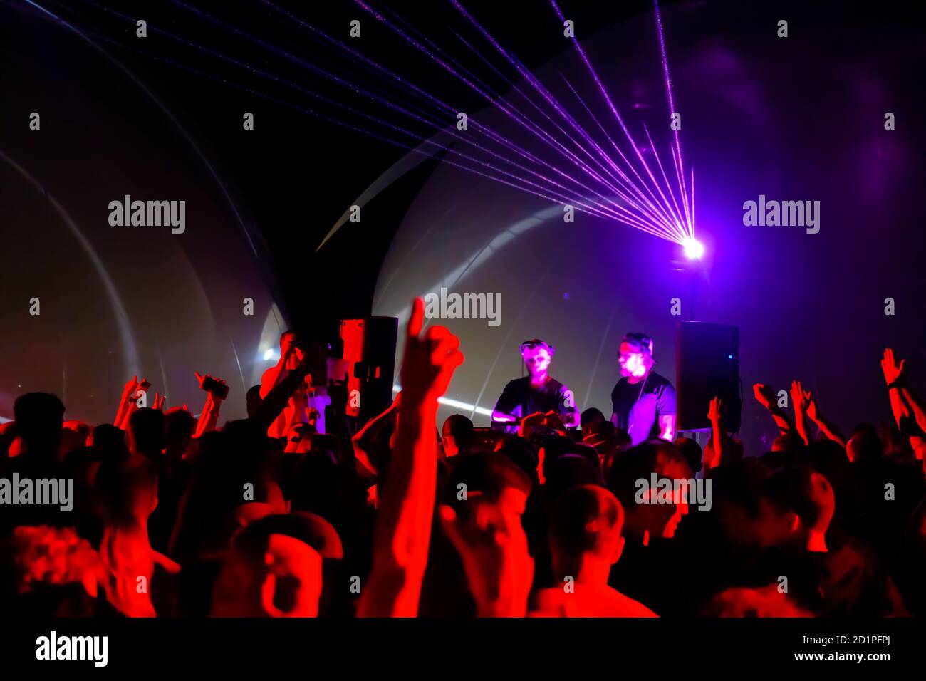 Crowd and DJs dancing during party Stock Photo - Alamy