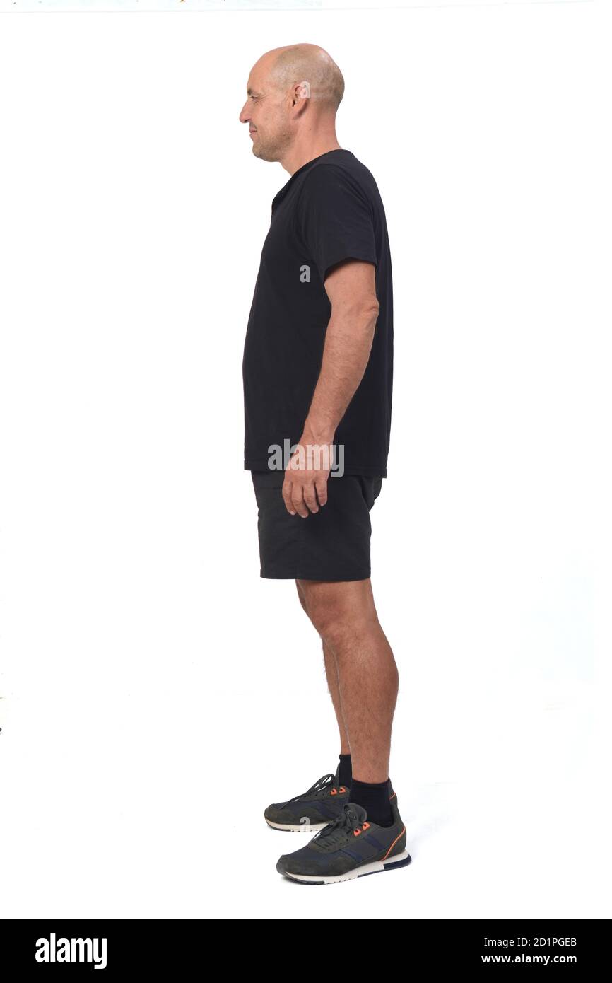 side view of a man wearing sportswear t-shirt and shorts on white ...