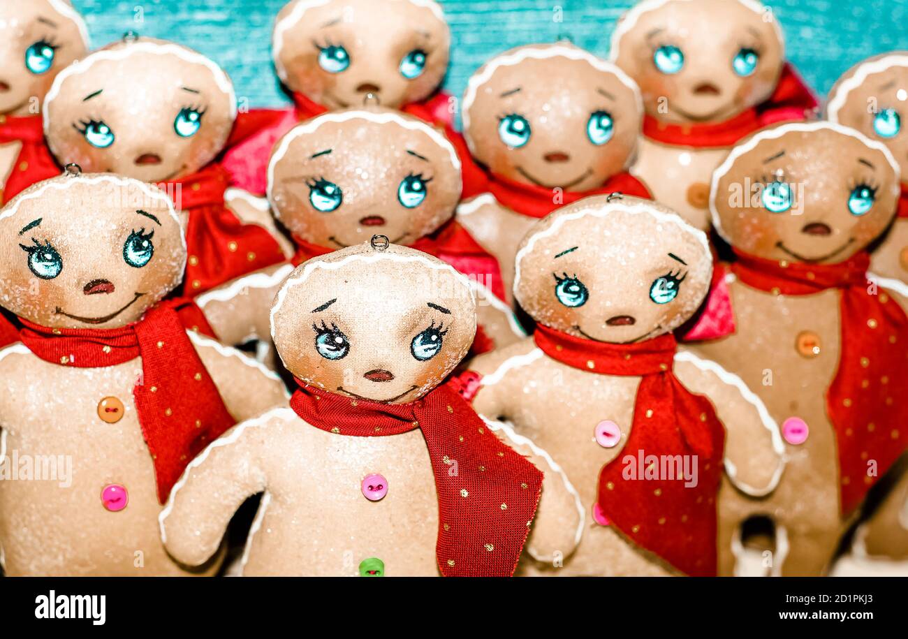 A lot of gingerbread men in red scarves on a gray-blue background ...