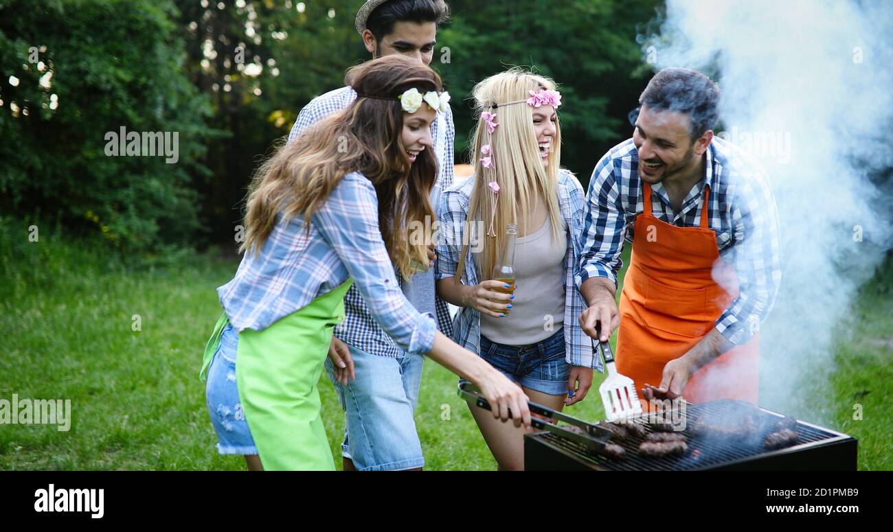 Friends spending time in nature and having barbecue Stock Photo - Alamy