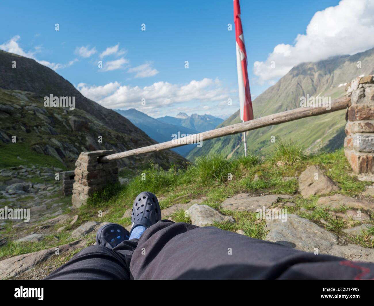 hikers legs, foot in rubber clogs relaxing at view from Nurnberger ...
