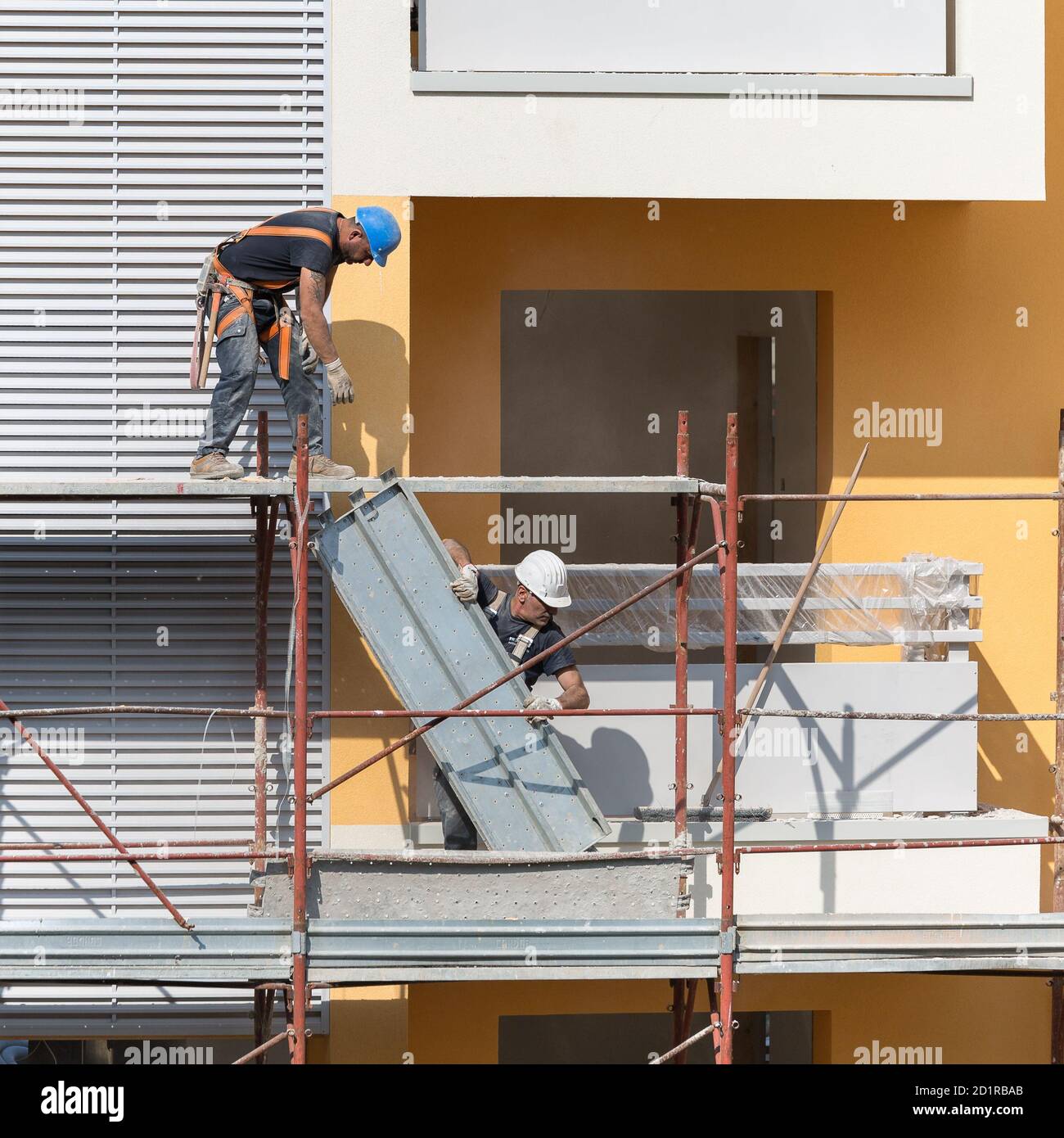 Workers at Work on a Scaffold in a Building Site for the Construction ...