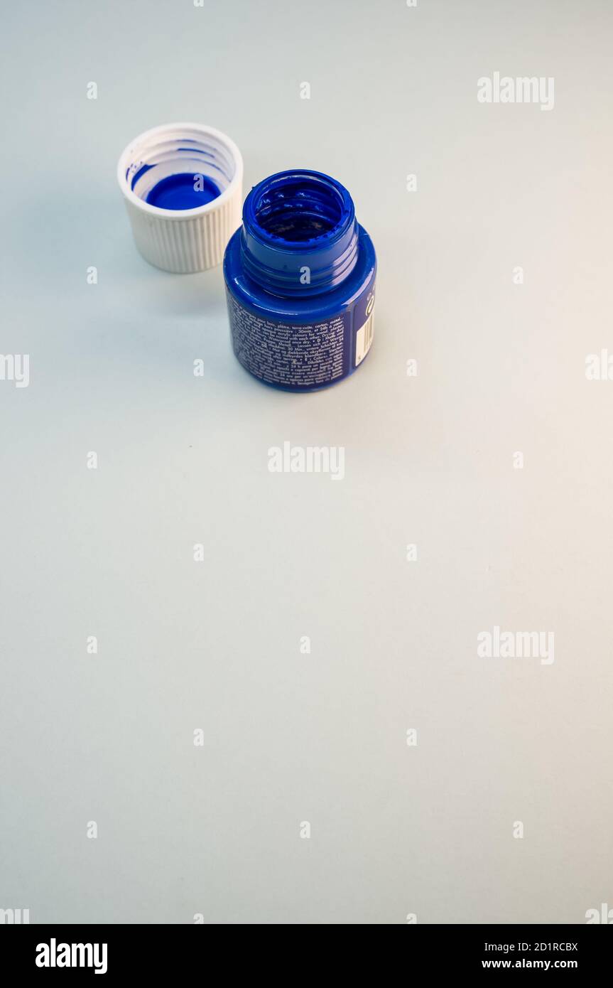 Closeup of the acrylic blue paint in the bottle with the lid on the ...