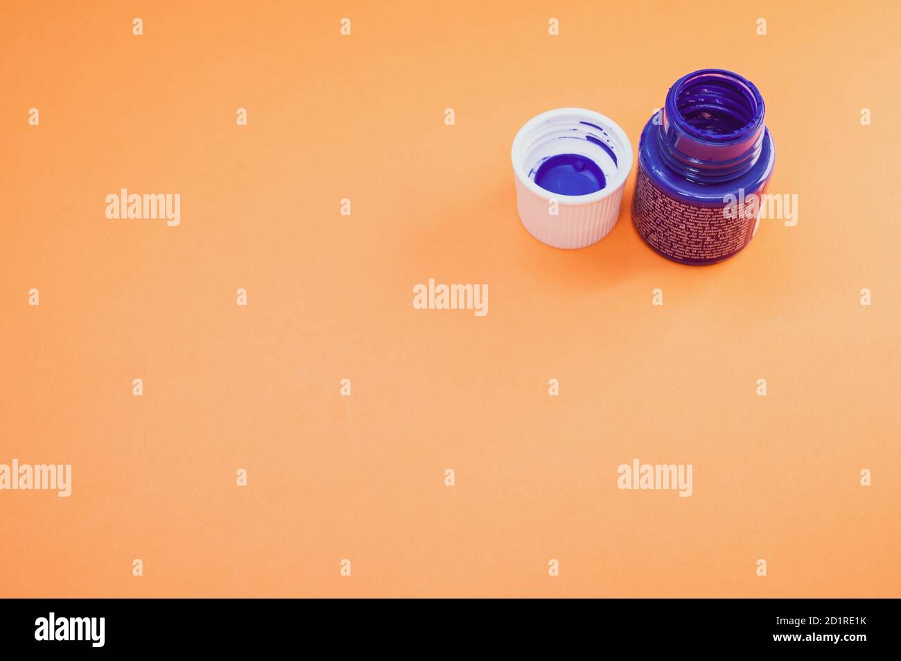 Closeup of the acrylic blue paint in the bottle with the lid on the ...
