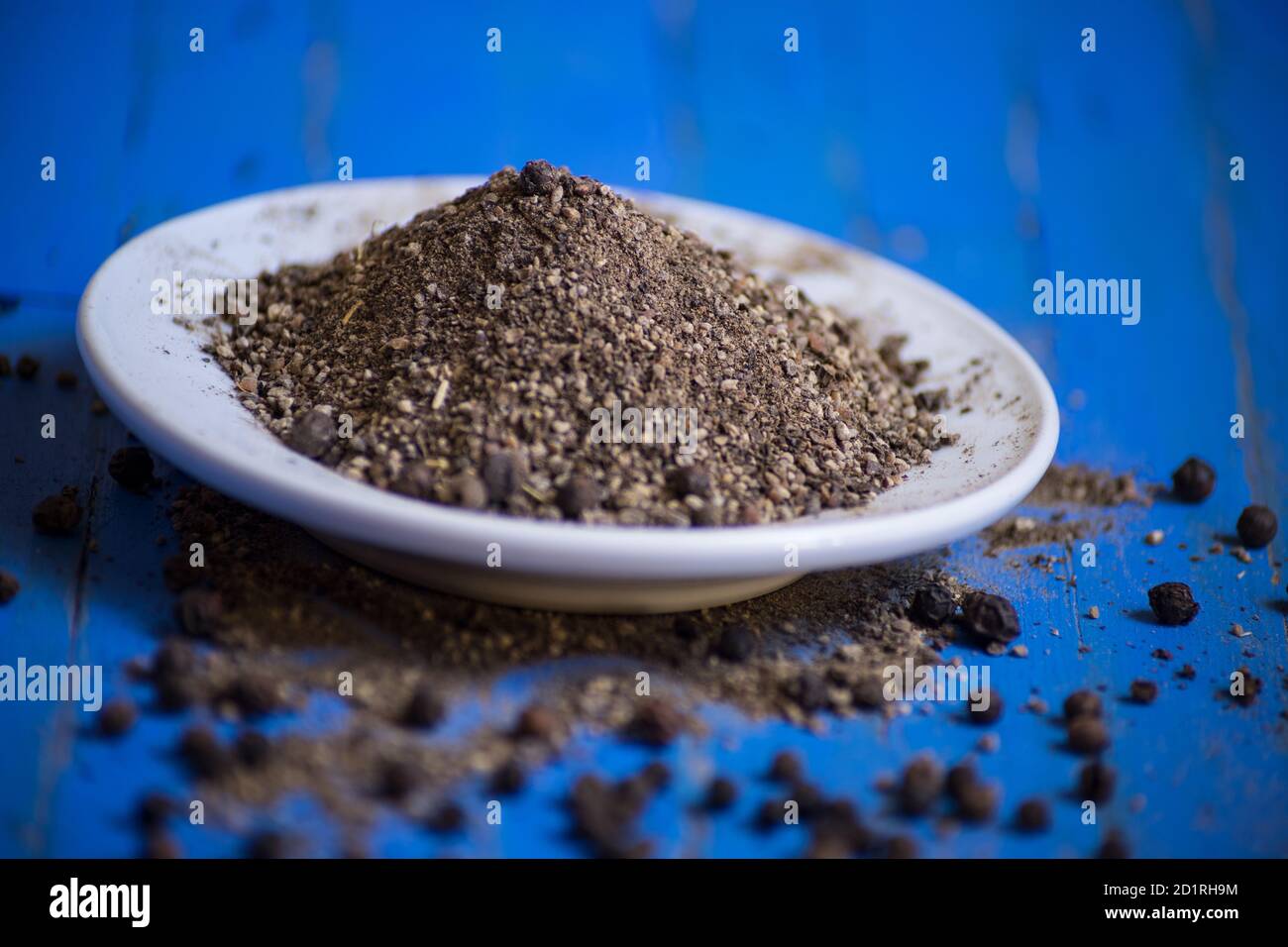 Close-up pf Pile of black powder pepper in white Plate and dry ...