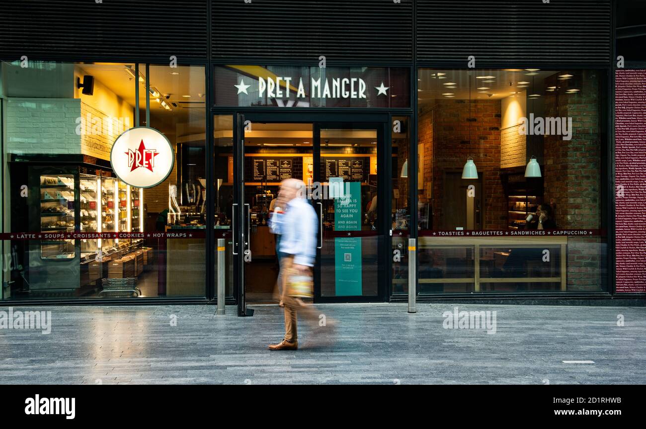 A blur of people walk past a Pret a Manger food retail chain cafe in ...