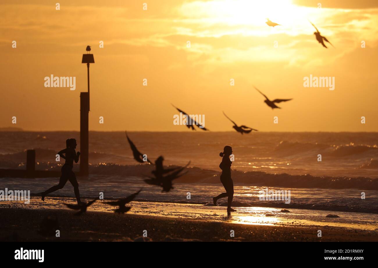 Two swimmers run into sea hi-res stock photography and images - Alamy