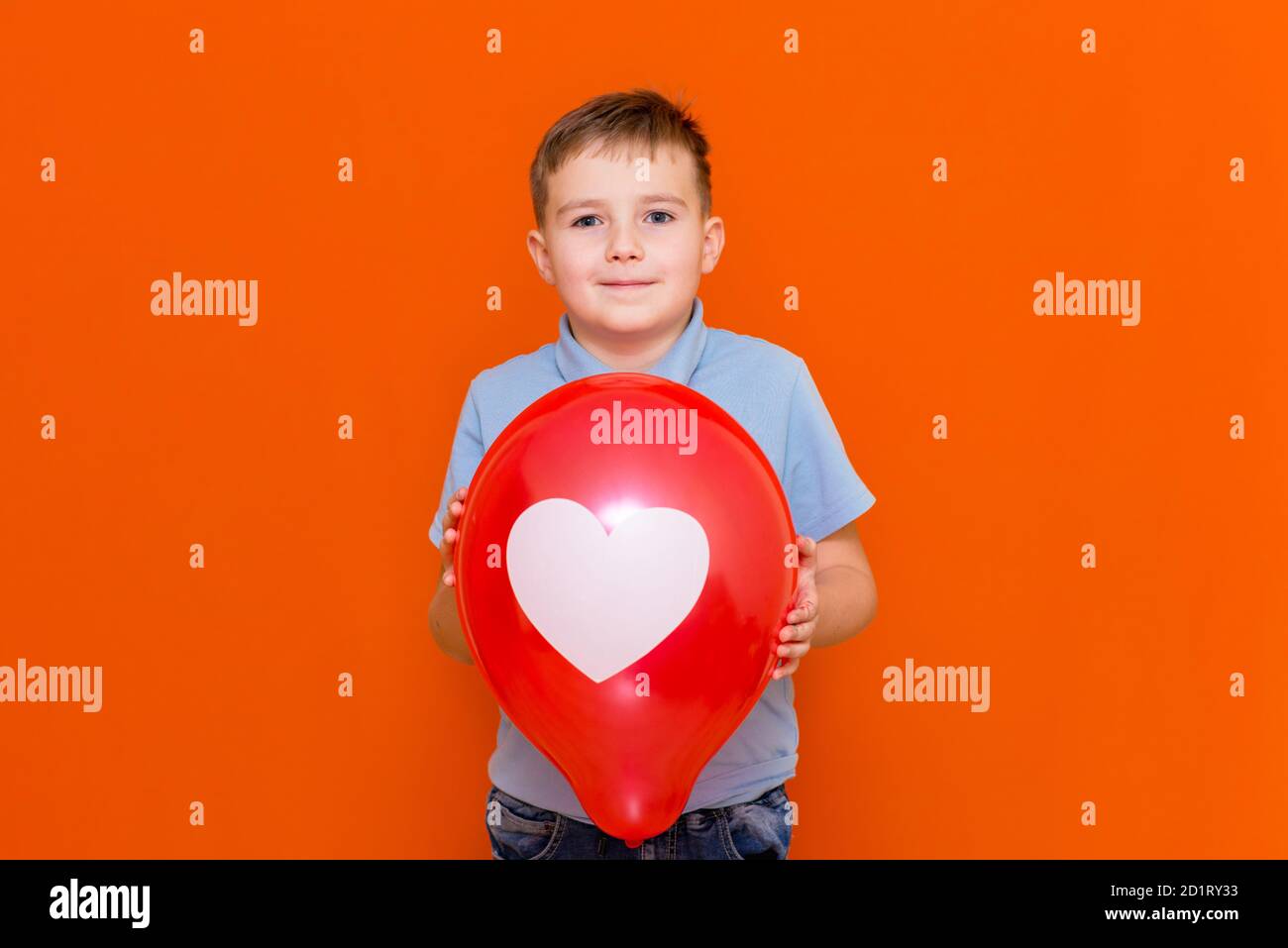 Close up Valentine's Day. Happy caucasian joyful young boy holding a ...