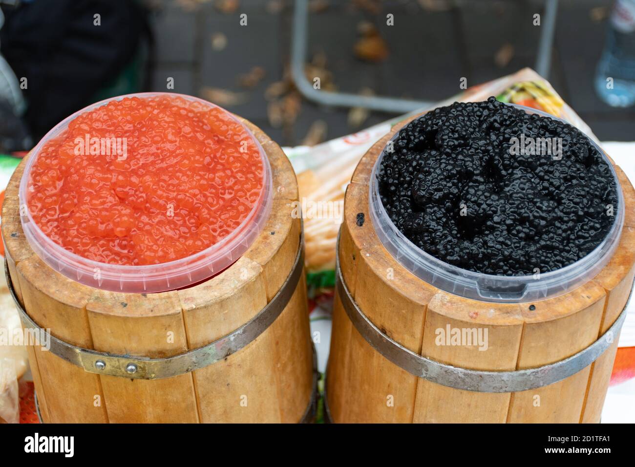 Salmon roe and sturgeon red and black caviar served in a wooden barrel ...