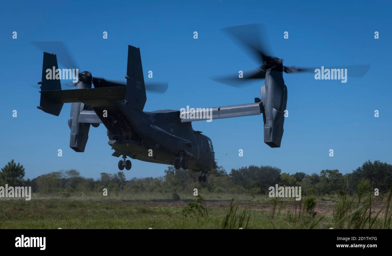 A CV-22B Osprey tiltrotor aircraft takes off after a landing approach ...