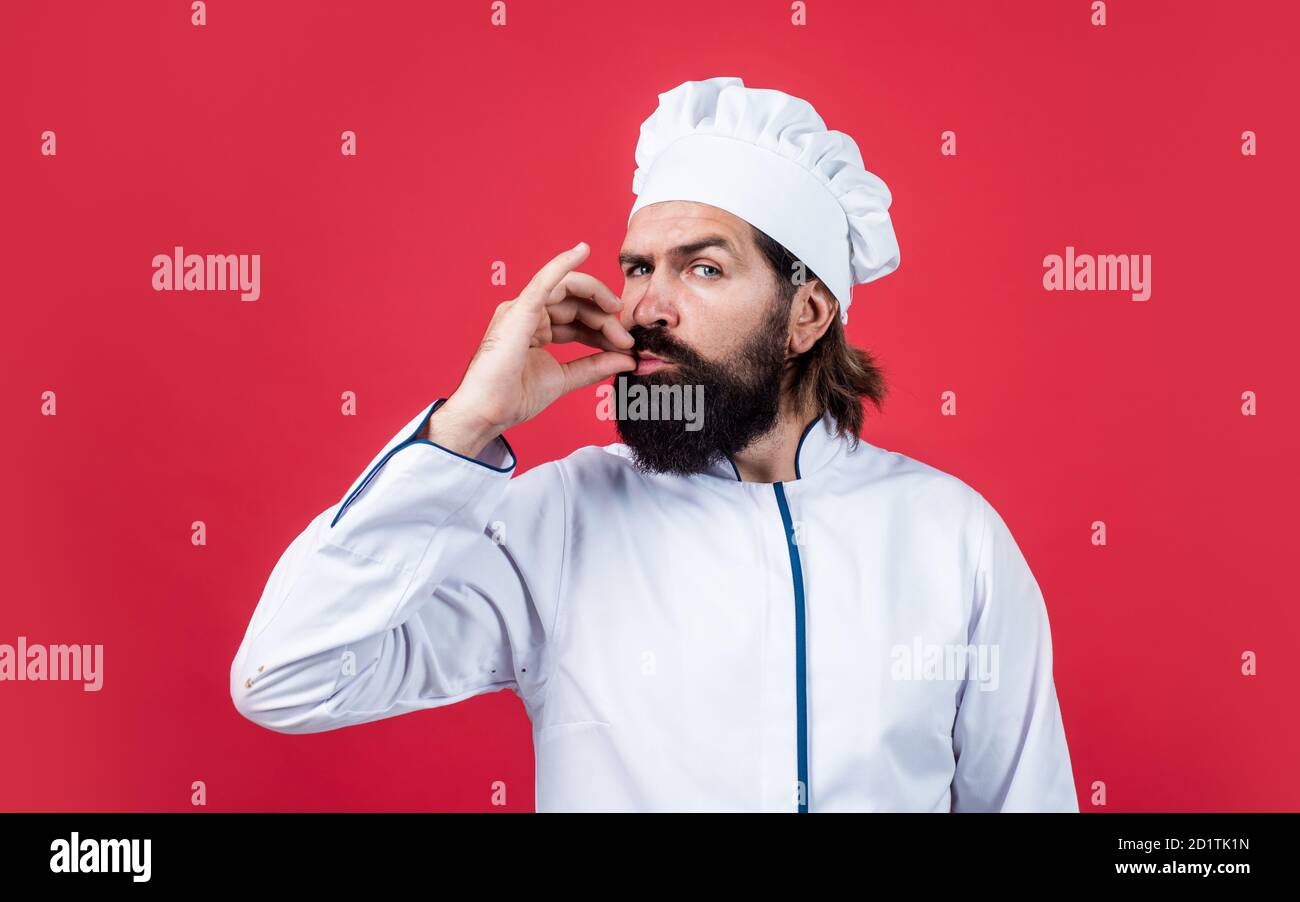 confident chef man with beard and moustache in cook uniform show sigh ...