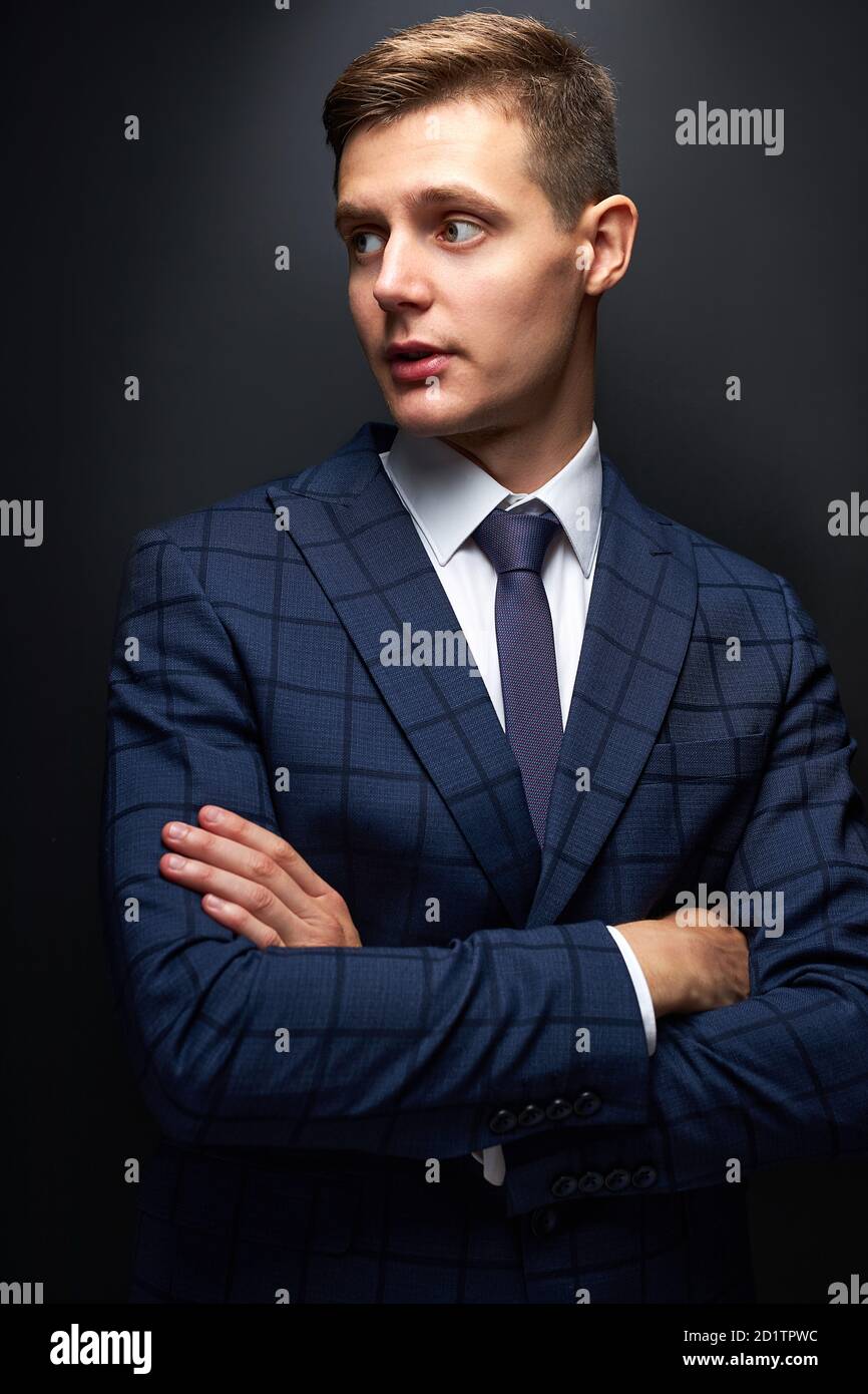 thoughtful young business man in classic black suit shirt posing ...