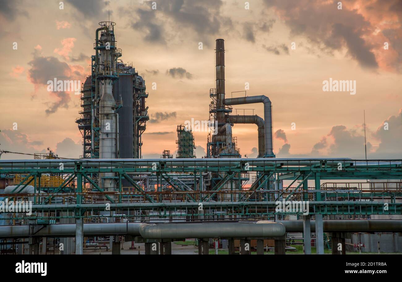 Refinery tower at a petrochemical plant with cloudy sky. After sunset ...