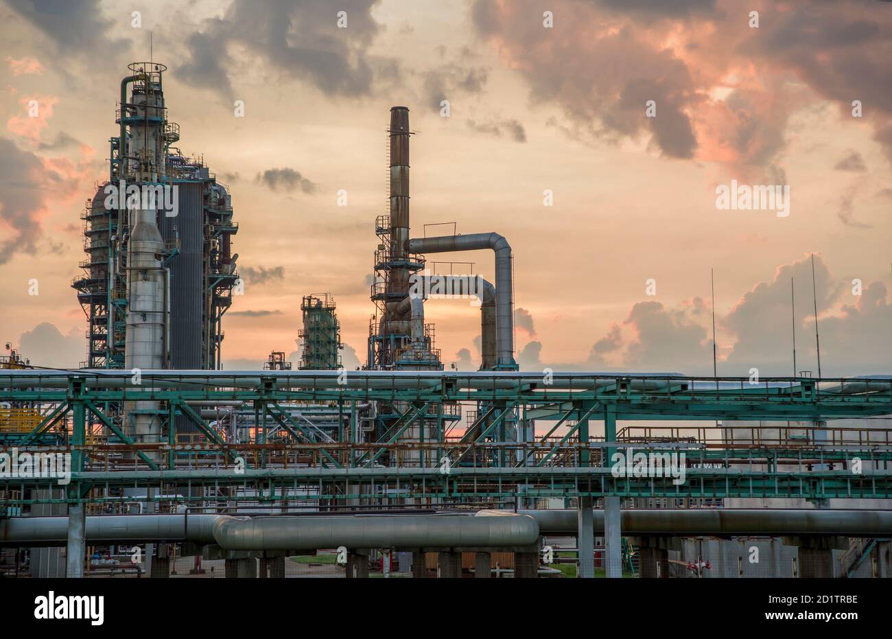 Refinery tower at a petrochemical plant with cloudy sky. After sunset ...
