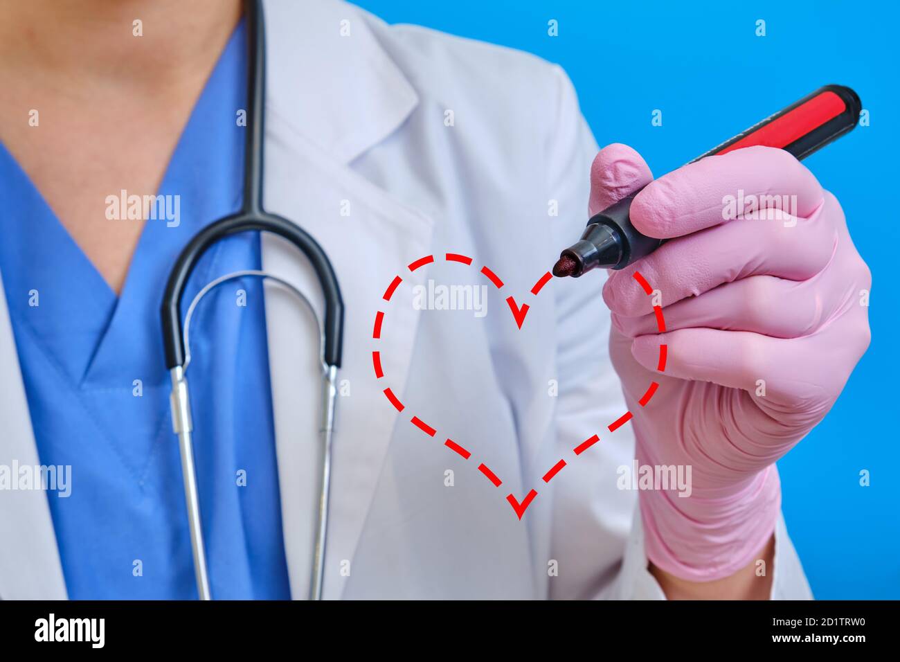 A cardiologist with a marker drew a heart, a copy space. A doctor's ...