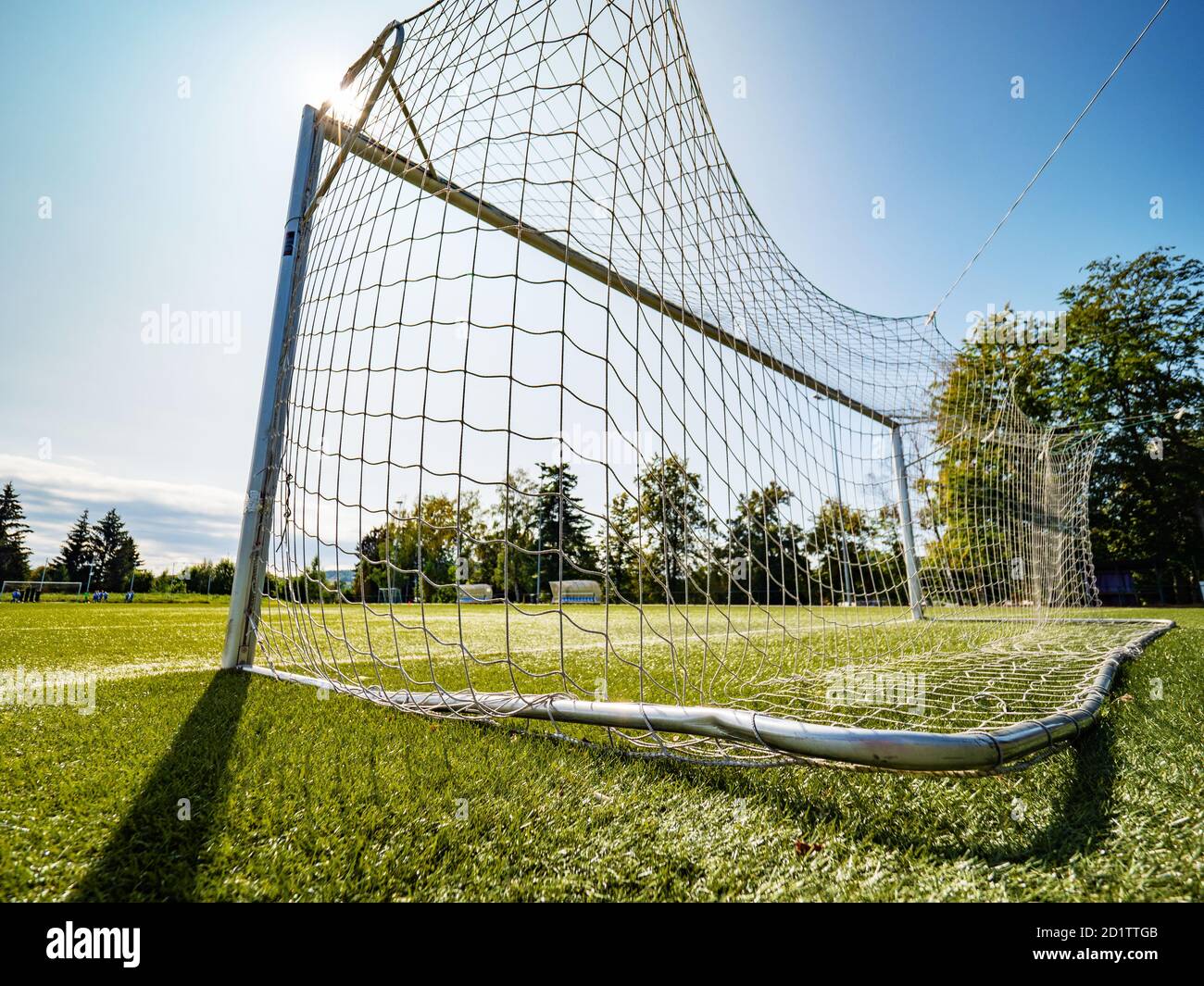 Look through net to football field in soccer stadium. Soccer field with ...
