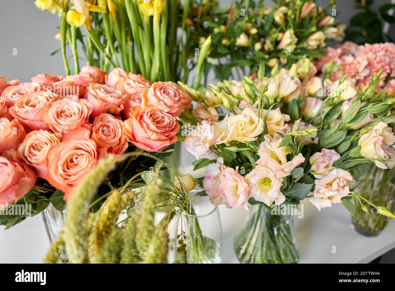 Many different colors on the stand or wooden table in the flower shop ...