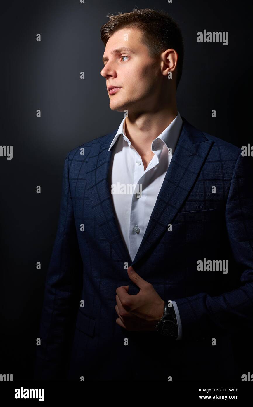 thoughtful young business man in classic black suit shirt posing ...