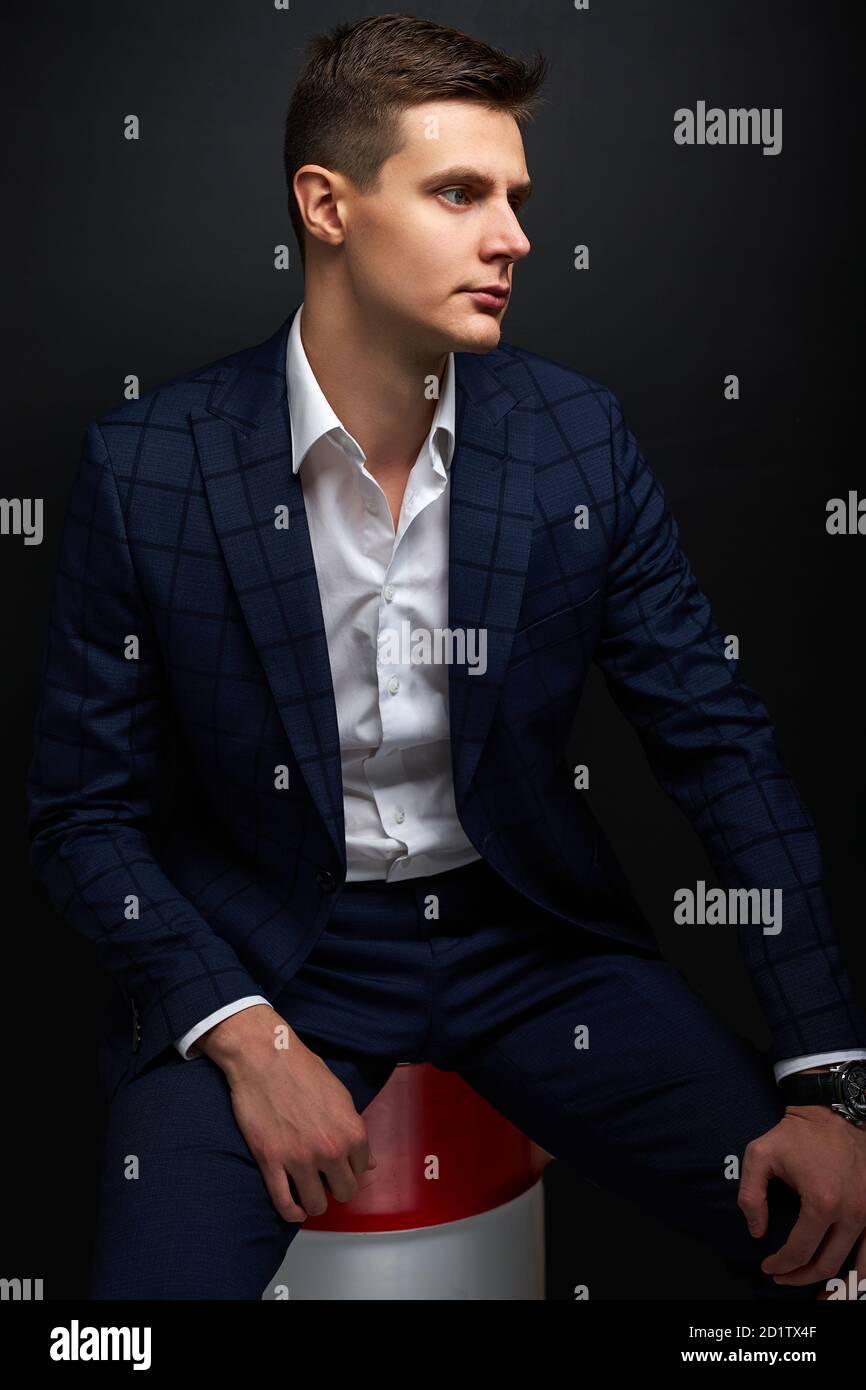 handsome business man owner of oil company sit on barrel posing ...