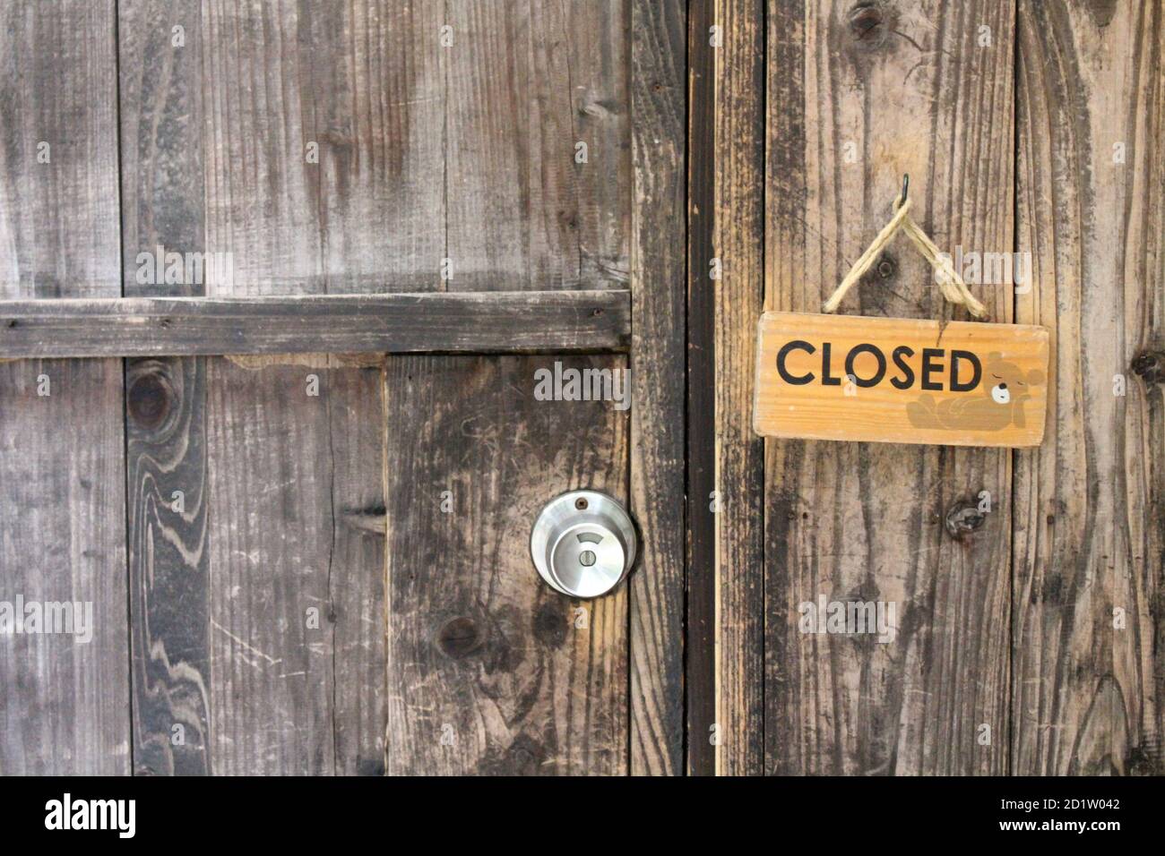 Japanese wooden door to hotspring pool or onsen, sign saying closed ...