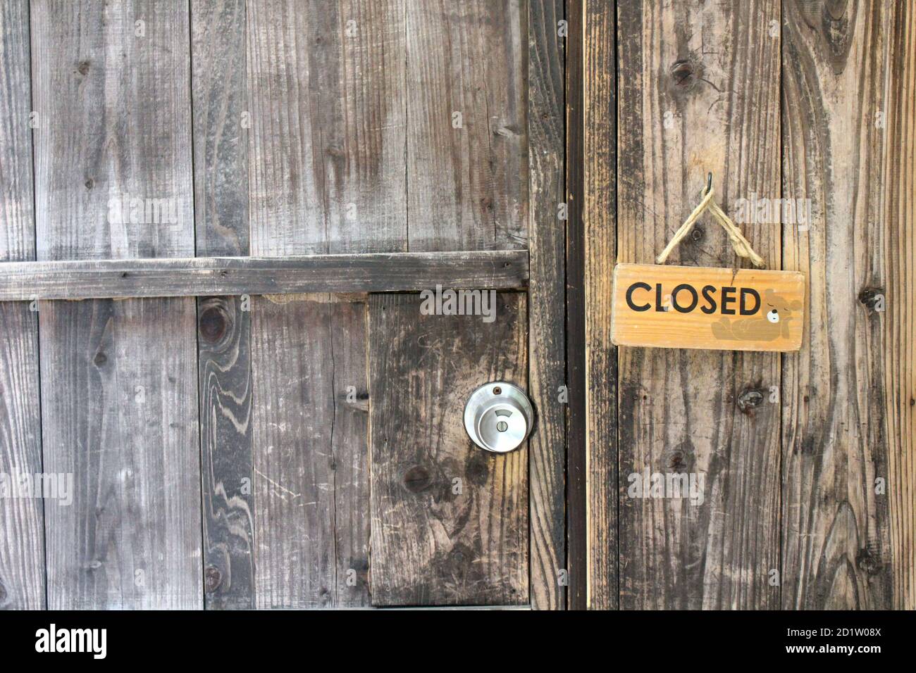 Japanese wooden door to hotspring pool or onsen, sign saying closed ...