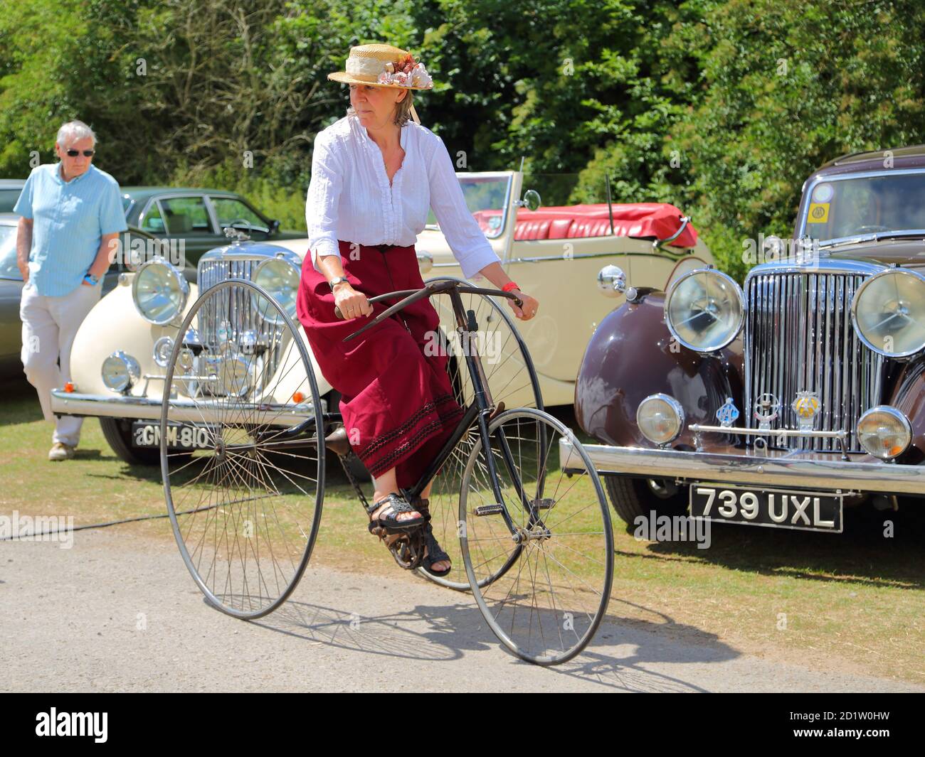 A woman riding a vintage tricycle at the Traditional Boat Festival in ...