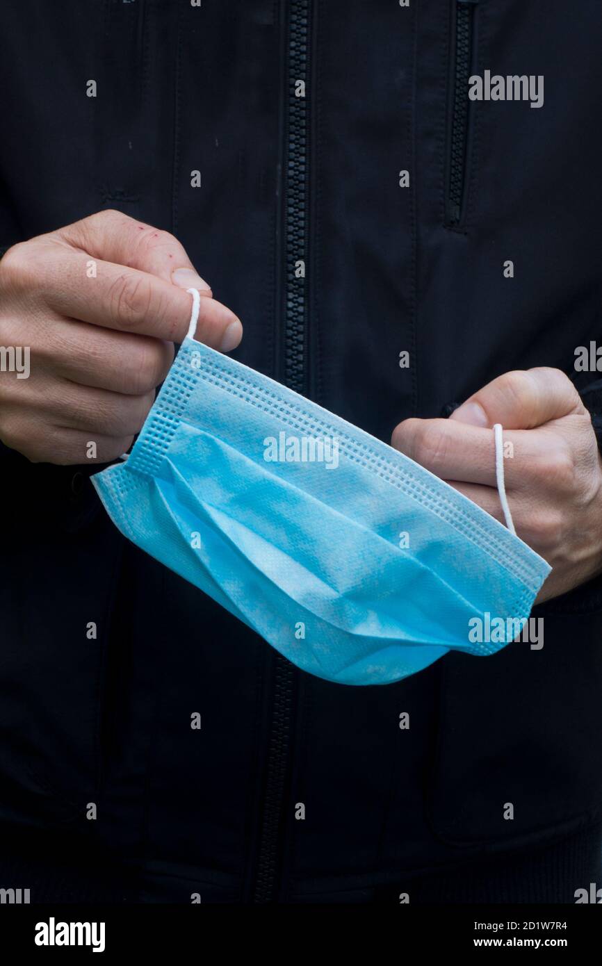 Man holding mask face hi-res stock photography and images - Alamy